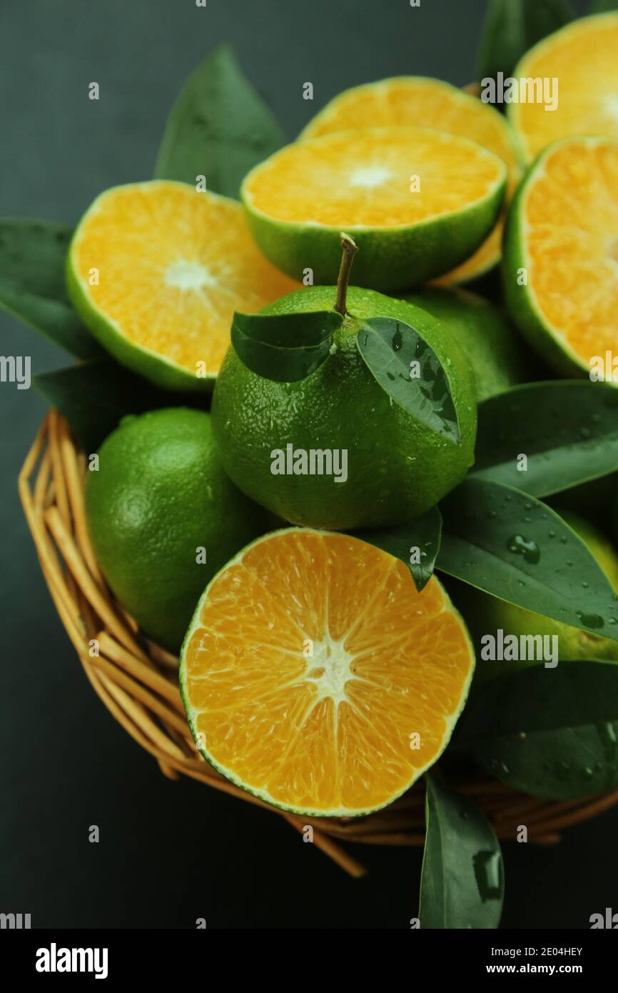 Green sweet tangerines growing with background Stock Photo - Alamy
