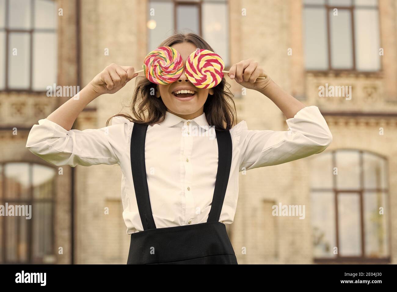 Cheat meal day. Happy kid with sweet candy. Kid child holding lollipops ...