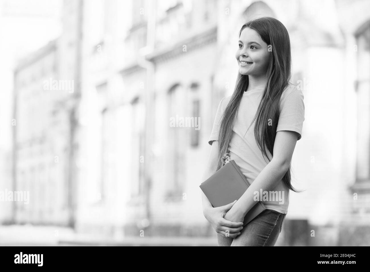 Studying of book. Happy child hold school book outdors. Enjoy studying ...