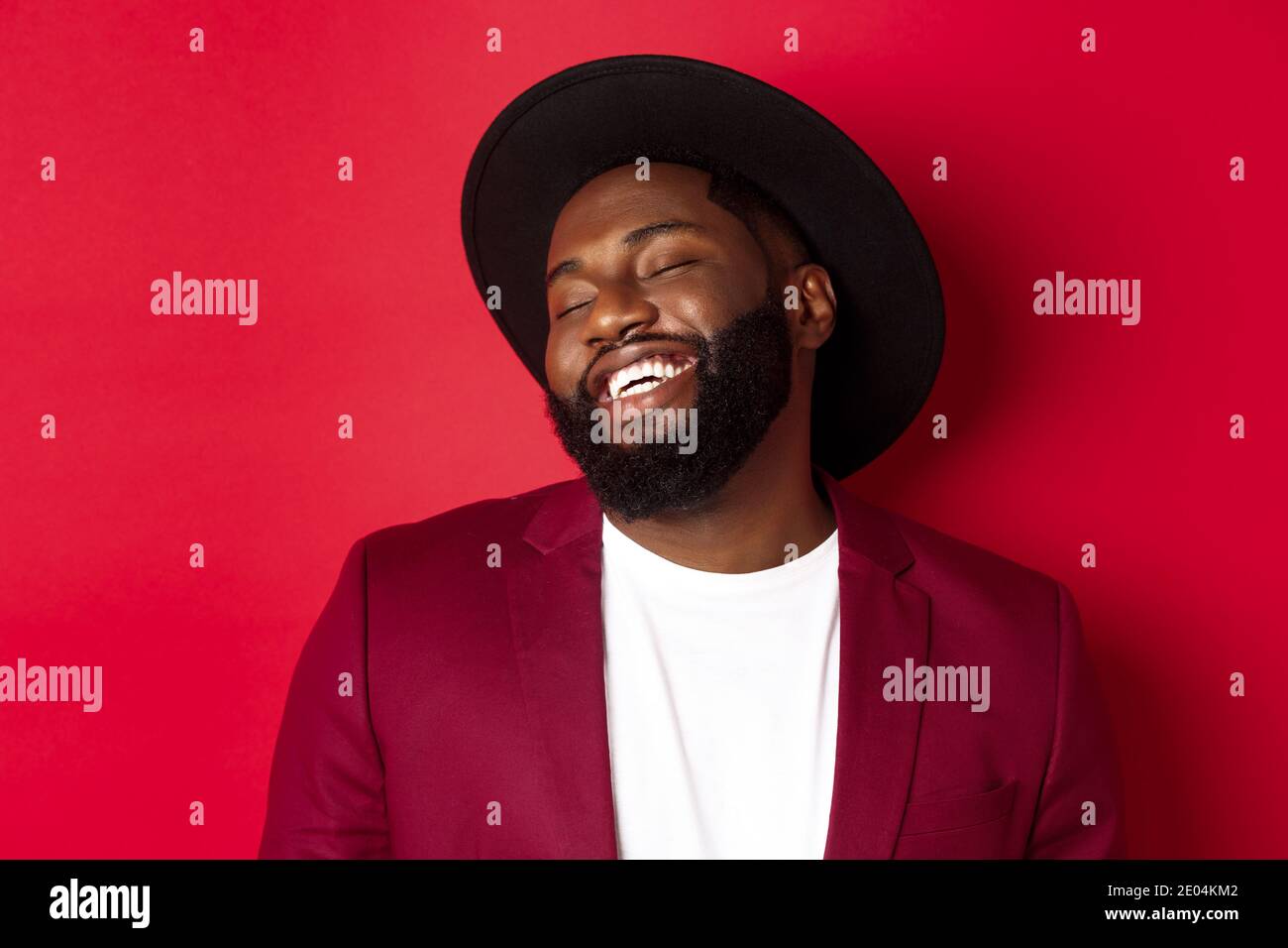 Close-up of handsome Black man with long beard laughing and having fun ...