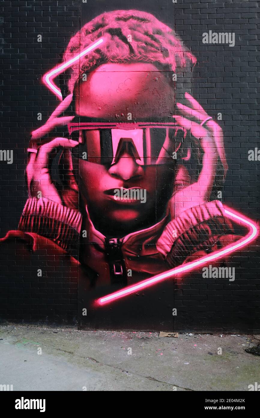 London, UK. 24 Dec 2020. Neon style graffiti of a woman by artist David ...