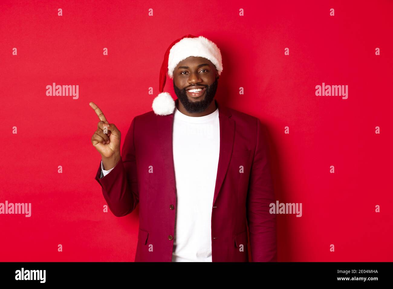 Christmas, party and holidays concept. Handsome Black man in santa hat ...