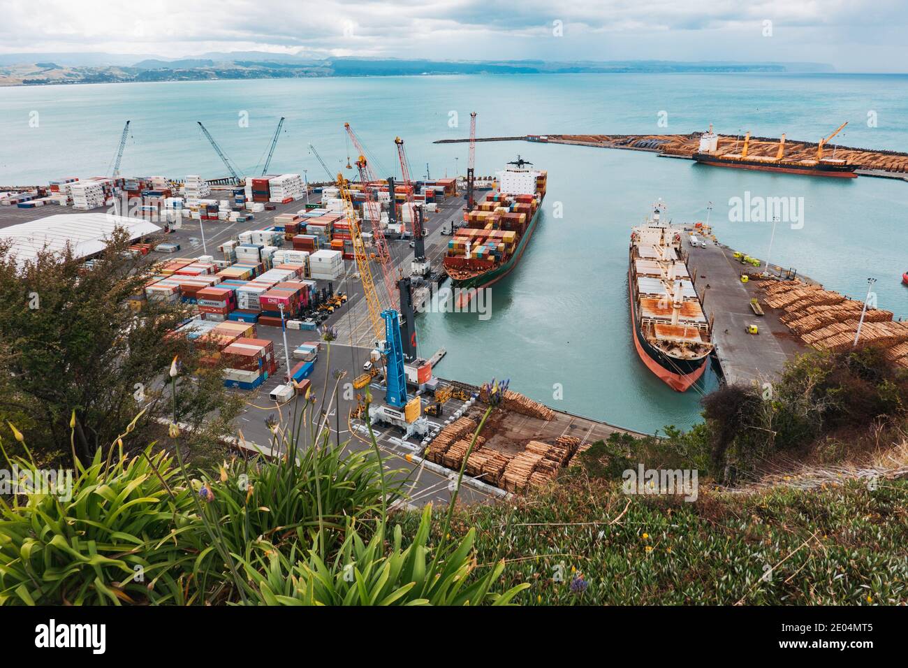 a container ship unloads containers alongside a bulk cargo vessel at ...