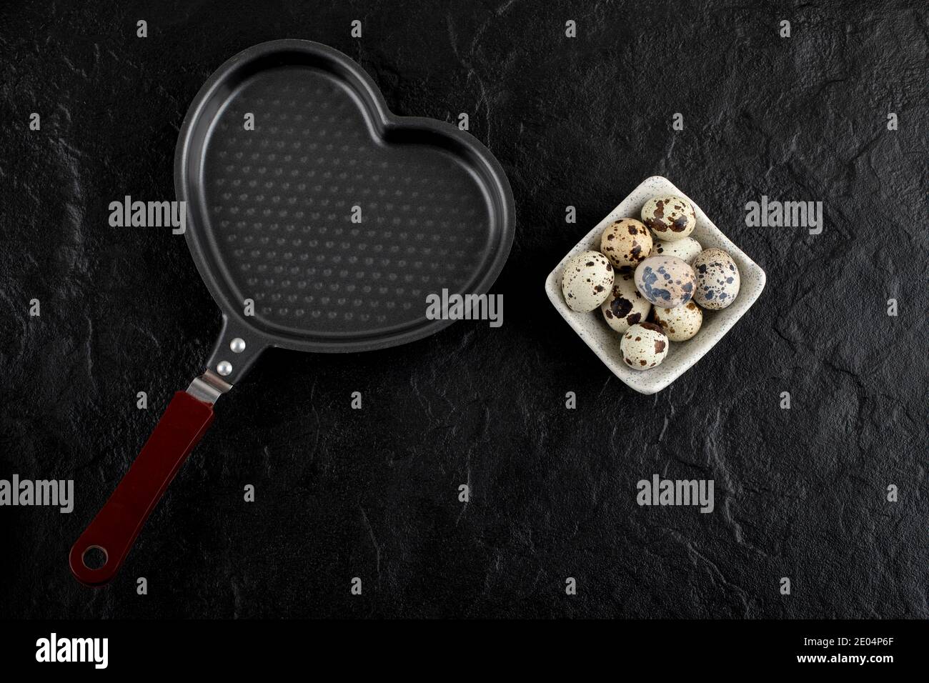 Bowl of quail eggs around empty heart shaped pan Stock Photo - Alamy