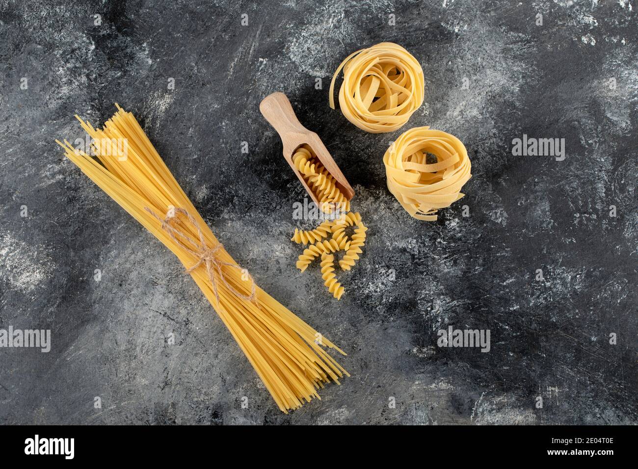 Tagliatelle nests, spaghetti and fusilli on marble background Stock ...