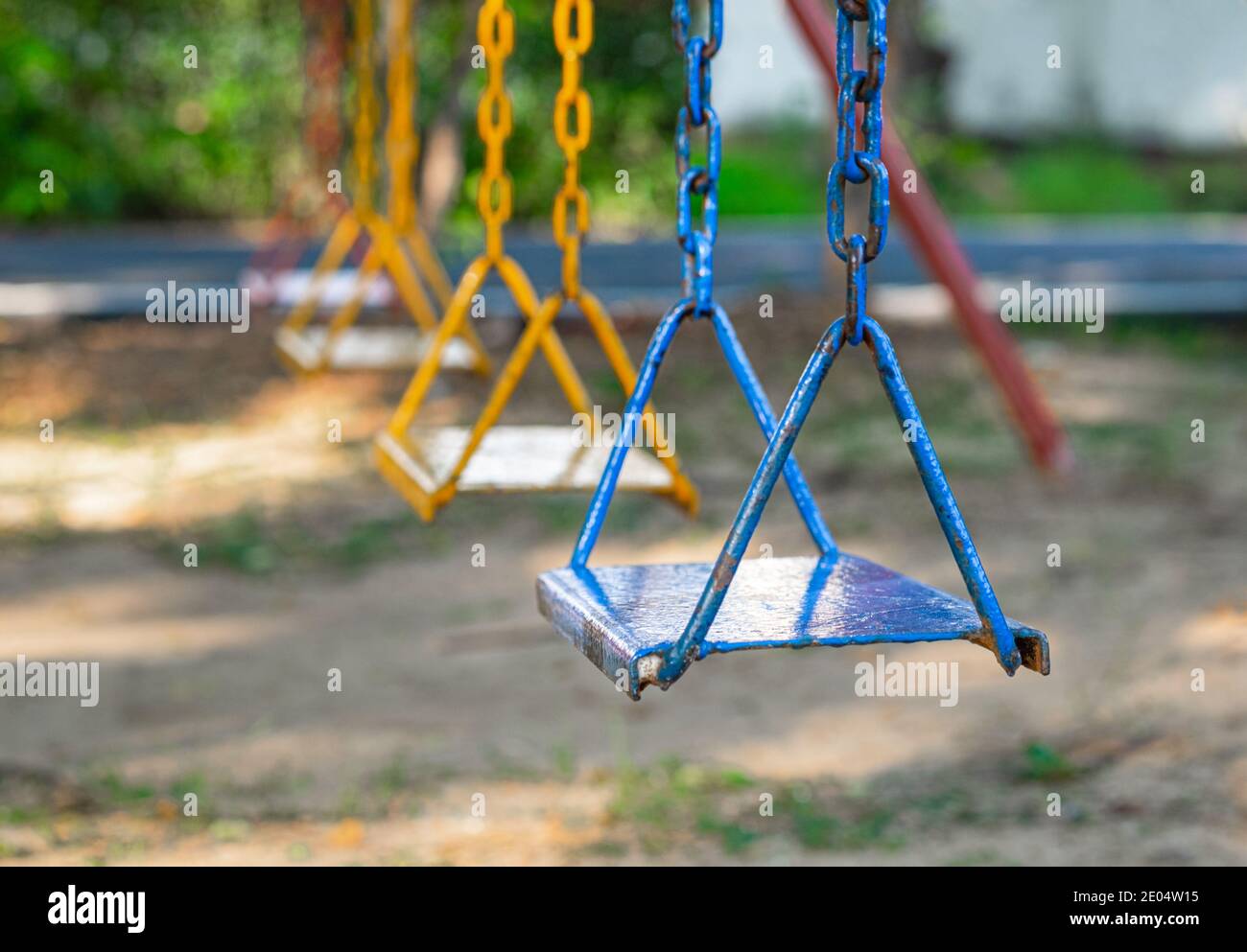 Blue and yellow swing set hi-res stock photography and images - Alamy