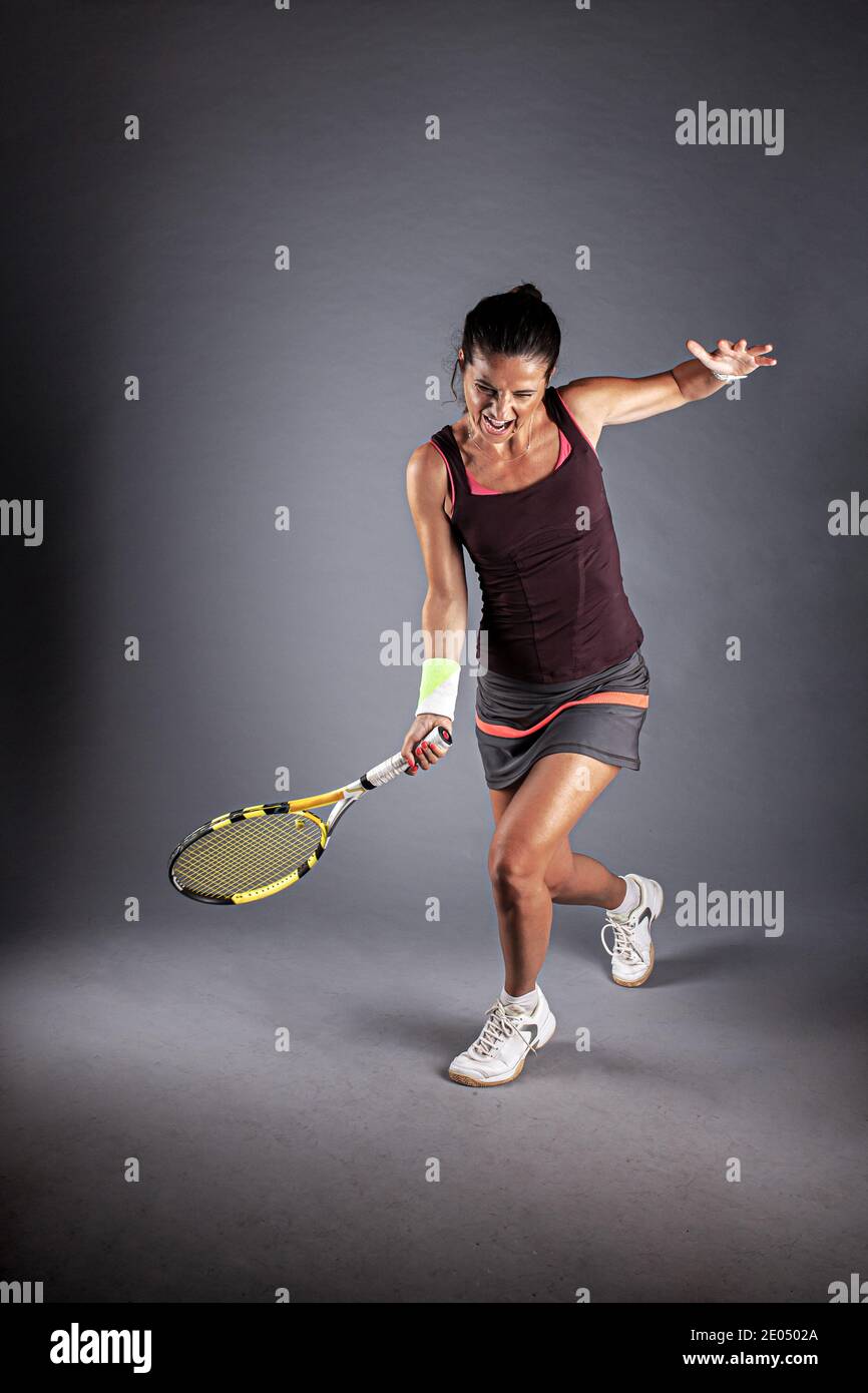 Professional female tennis player. Girl swinging racket Stock Photo - Alamy