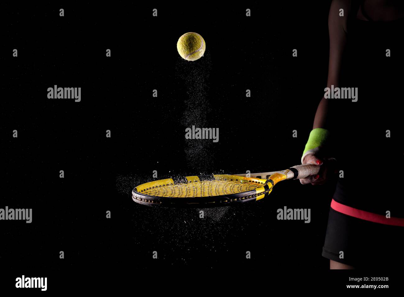 Tennis ball bouncing on racket. Dirt or magnesium dust dots visible in ...