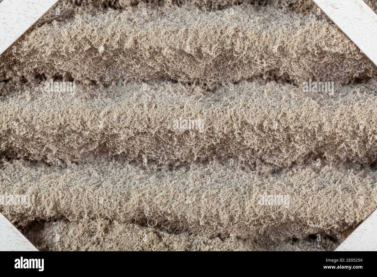 A heavily clogged furnace air filter. These filters are used to remove ...