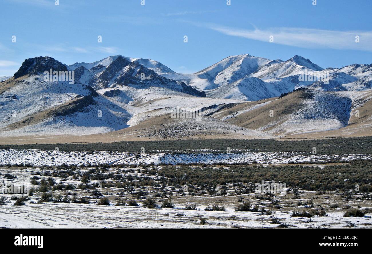 snow capped mountains tower over northern Nevada usa ranches and small ...