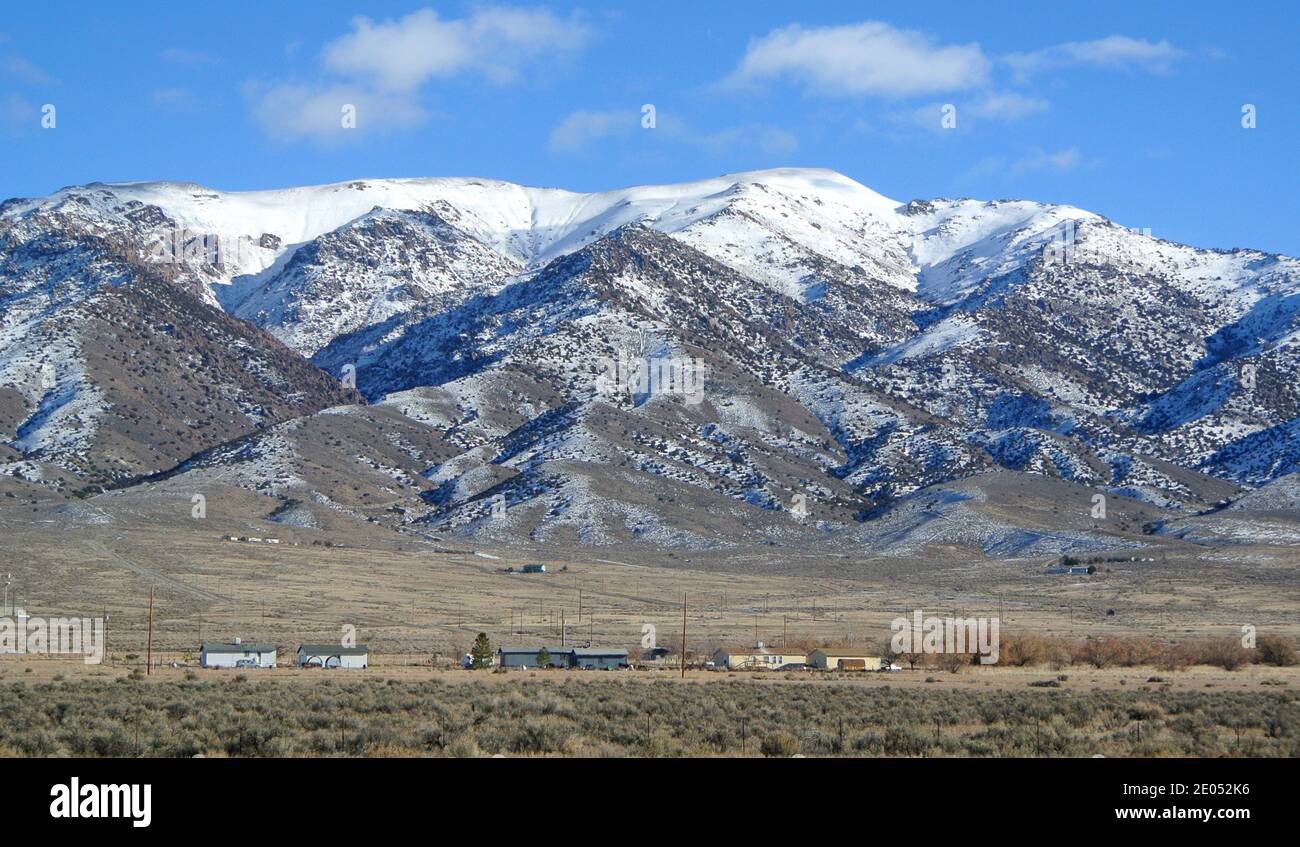 snow capped mountains tower over northern Nevada usa ranches and small ...