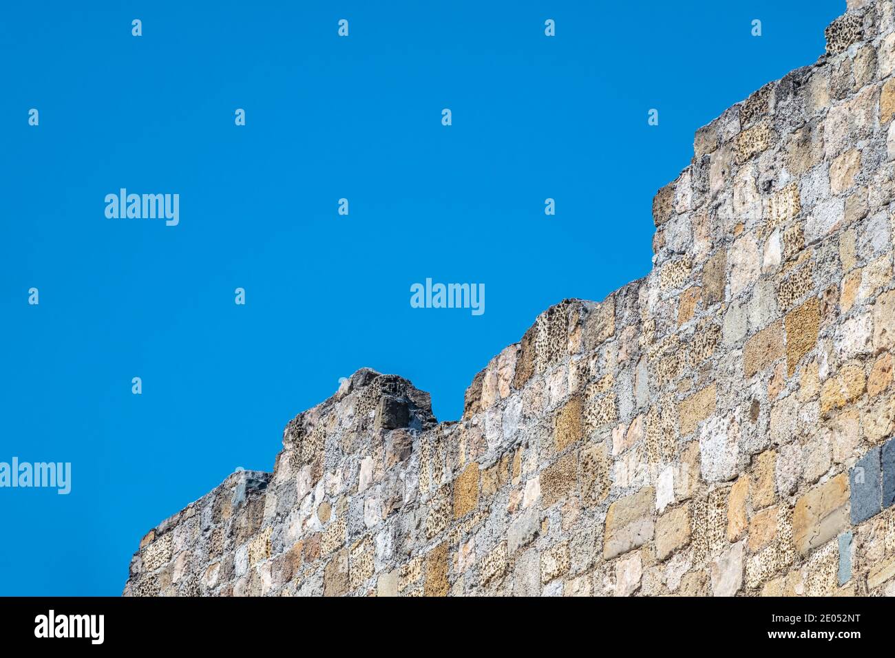 Ruins of the fortress wall against the blue sky. Ancient historic ...