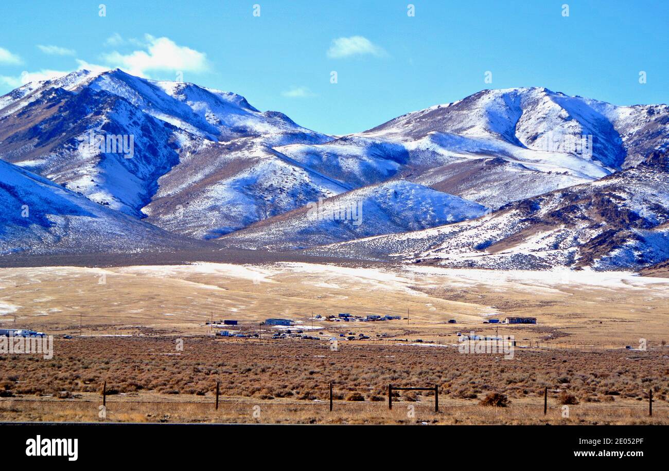 snow capped mountains tower over northern Nevada usa ranches and small ...