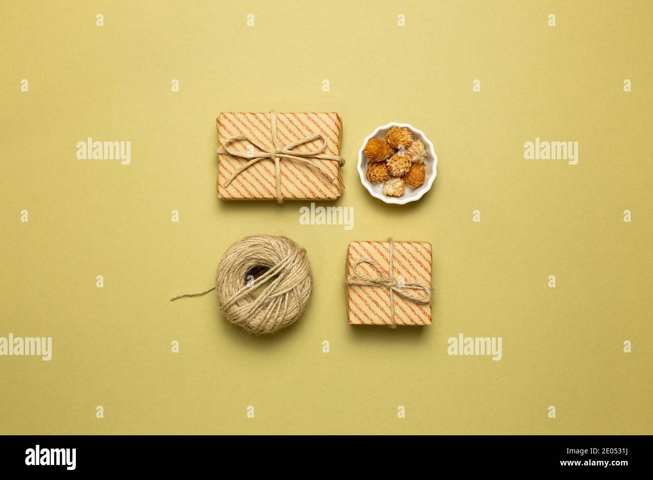 Gift boxes with dry flowers on khaki background. flat lay, top view ...