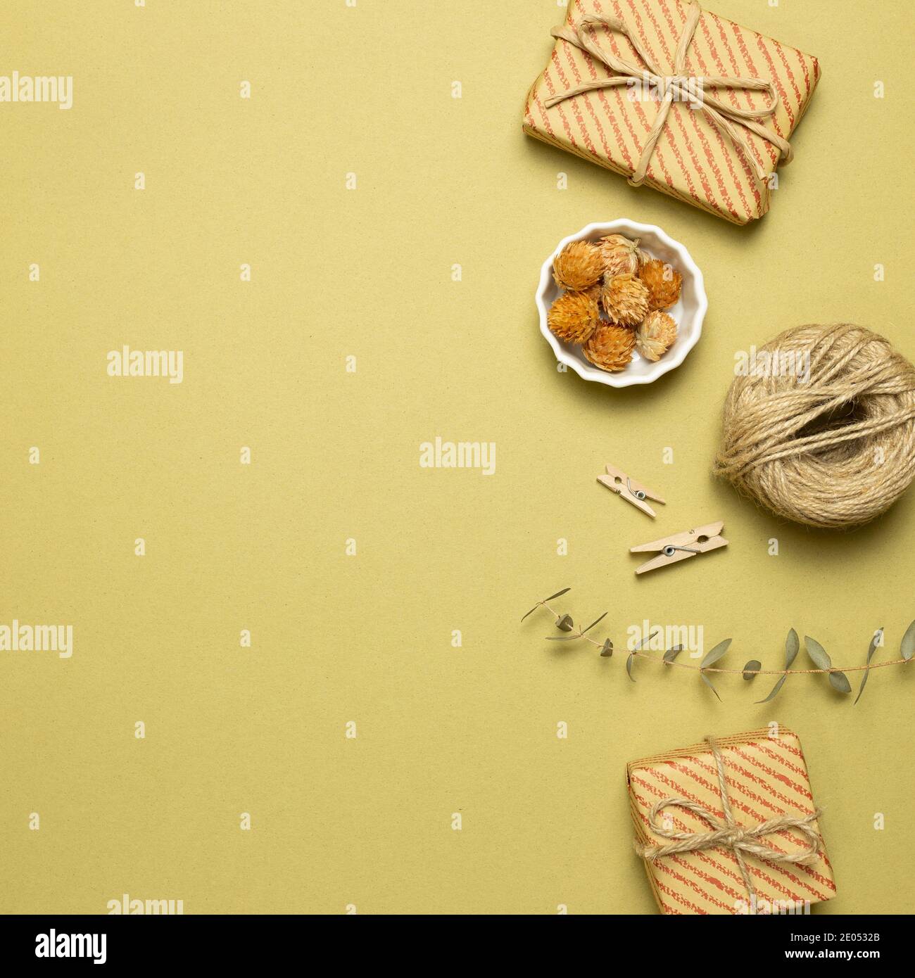 Gift boxes with dry flowers on khaki background. flat lay, top view ...