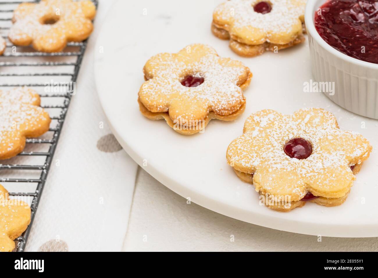 Flower shaped shortbread cookies filled with raspberry jam close up on ...