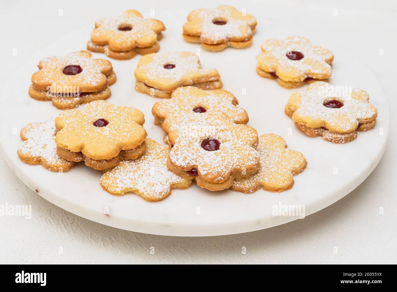Flower shaped shortbread cookies filled with raspberry jam close up on ...