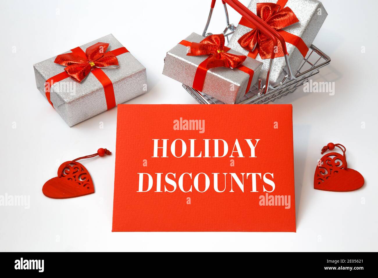 Shopping cart with holiday purchases and text HOLIDAY DISCOUNTS on a ...