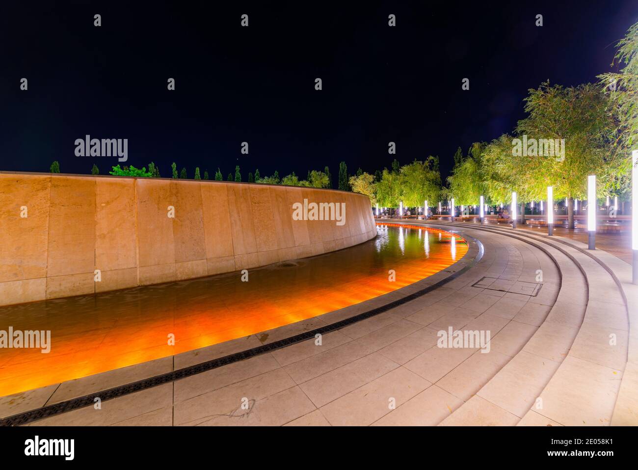 Walking path around fountain in resort with colored light illumination ...