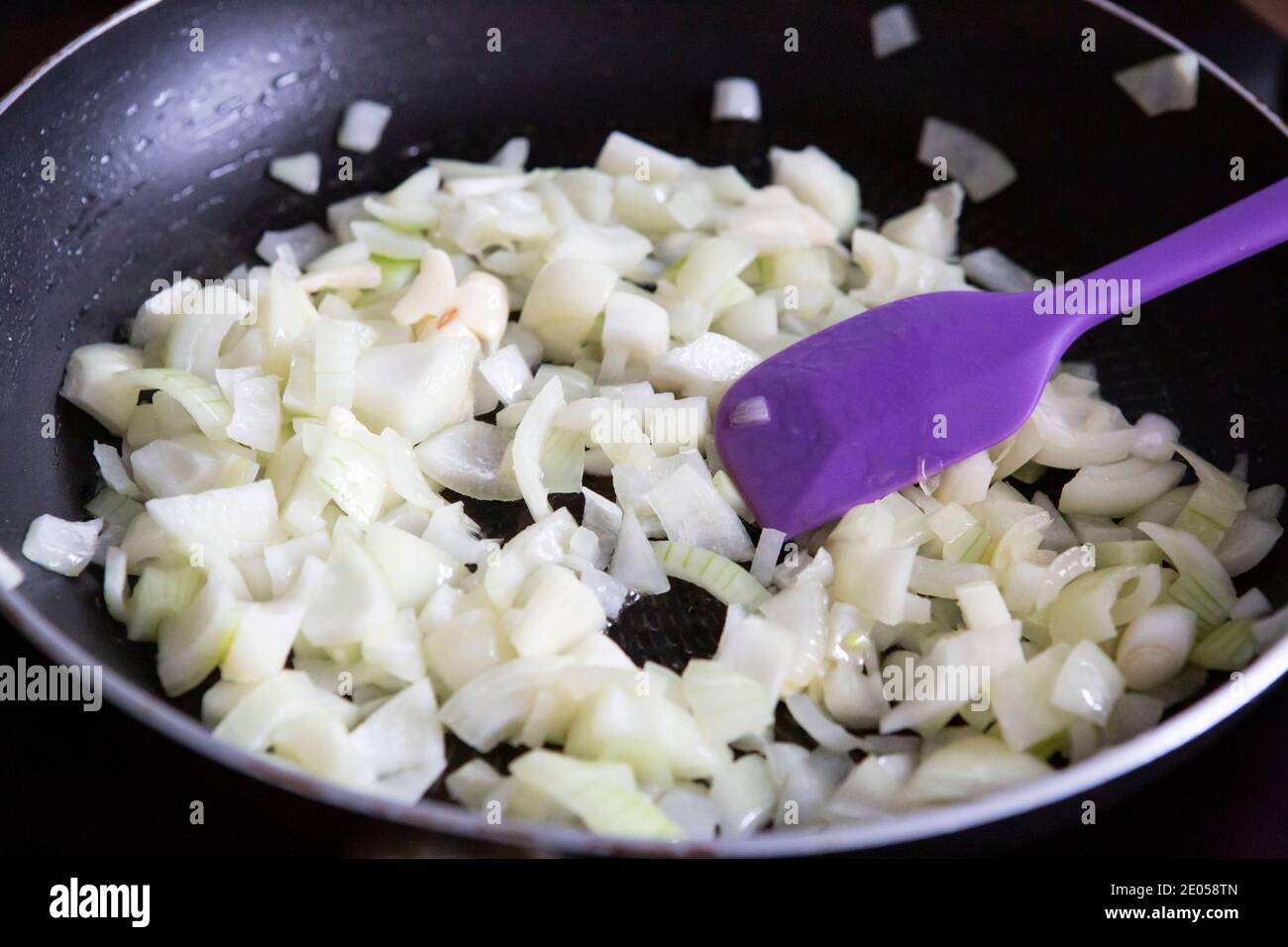 Onions cooking in a pan Stock Photo - Alamy