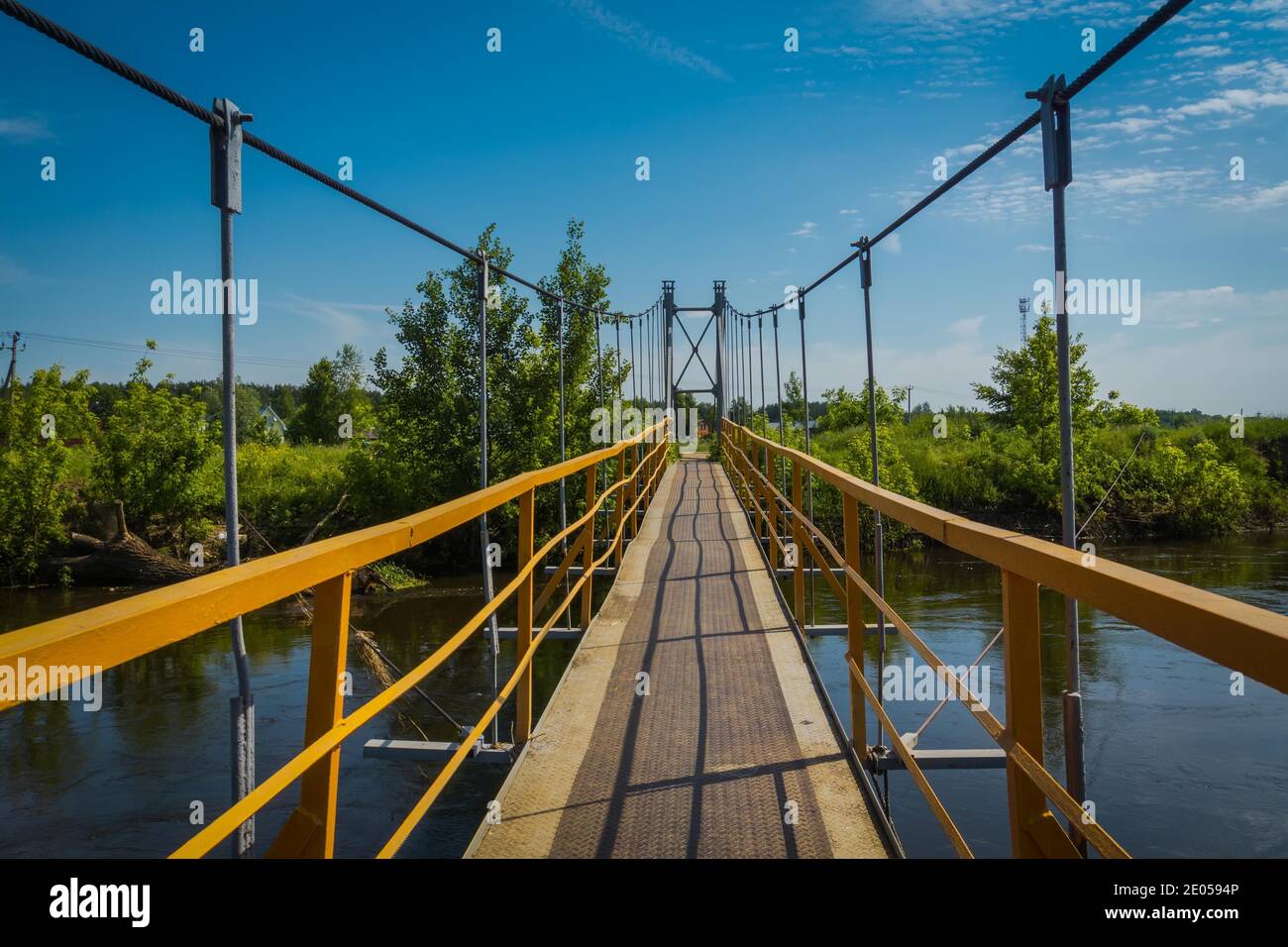 Old metal bridge over a small river in the countryside Stock Photo - Alamy
