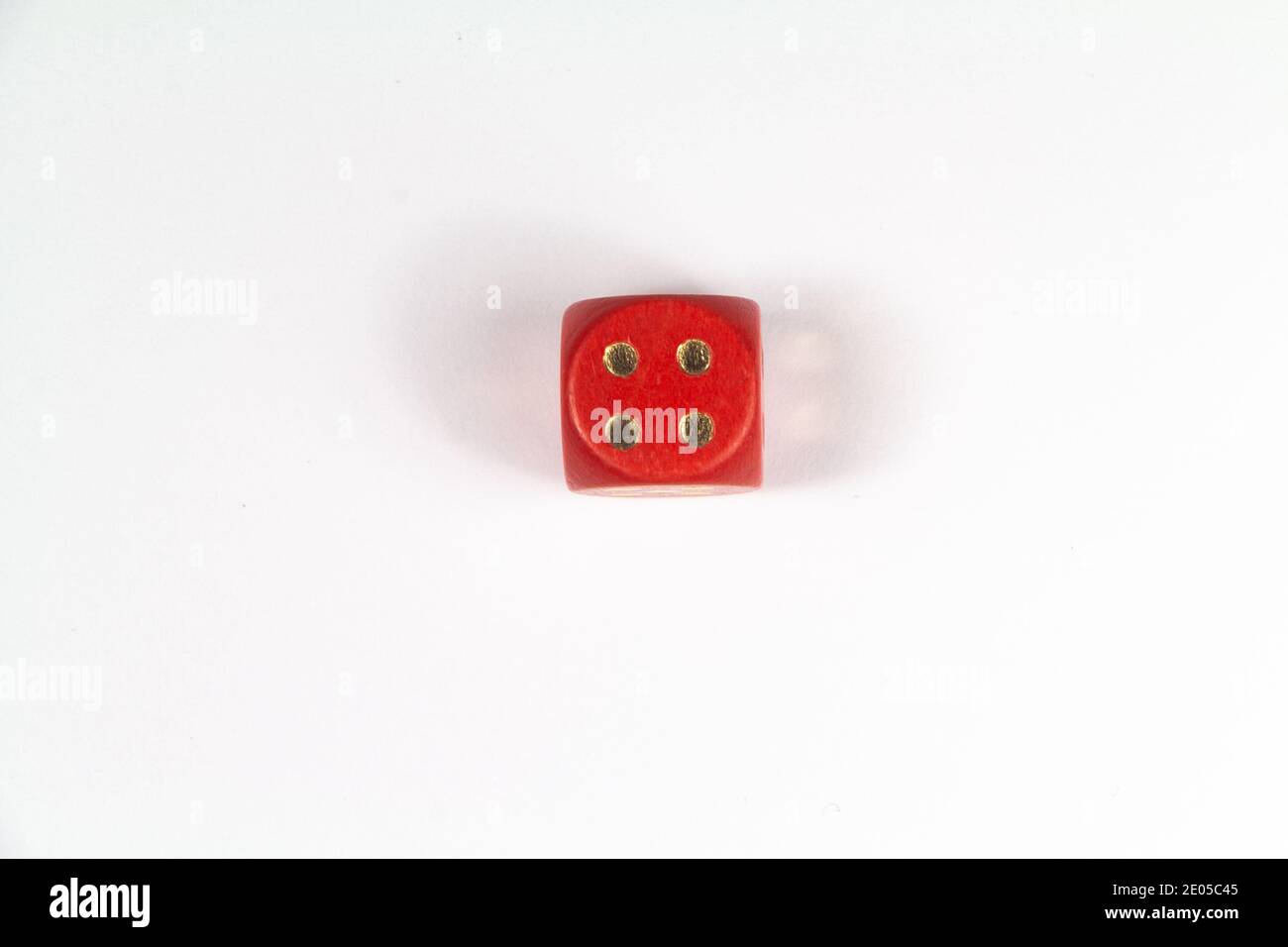 Red dice on the number four on white background Stock Photo - Alamy