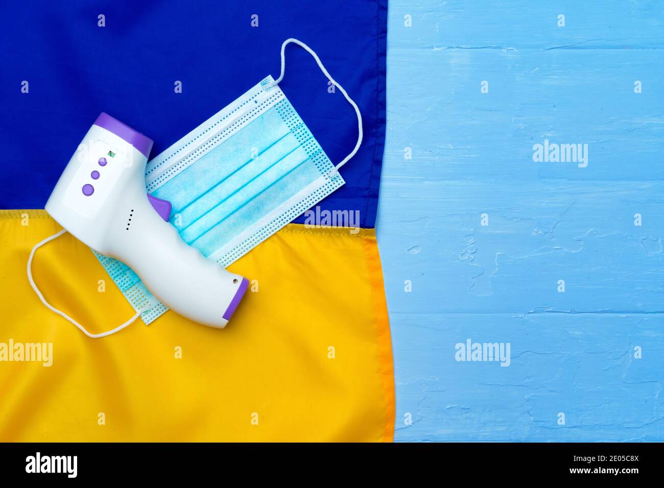 Medical mask and contactless thermometer on the flag of Ukraine Stock ...