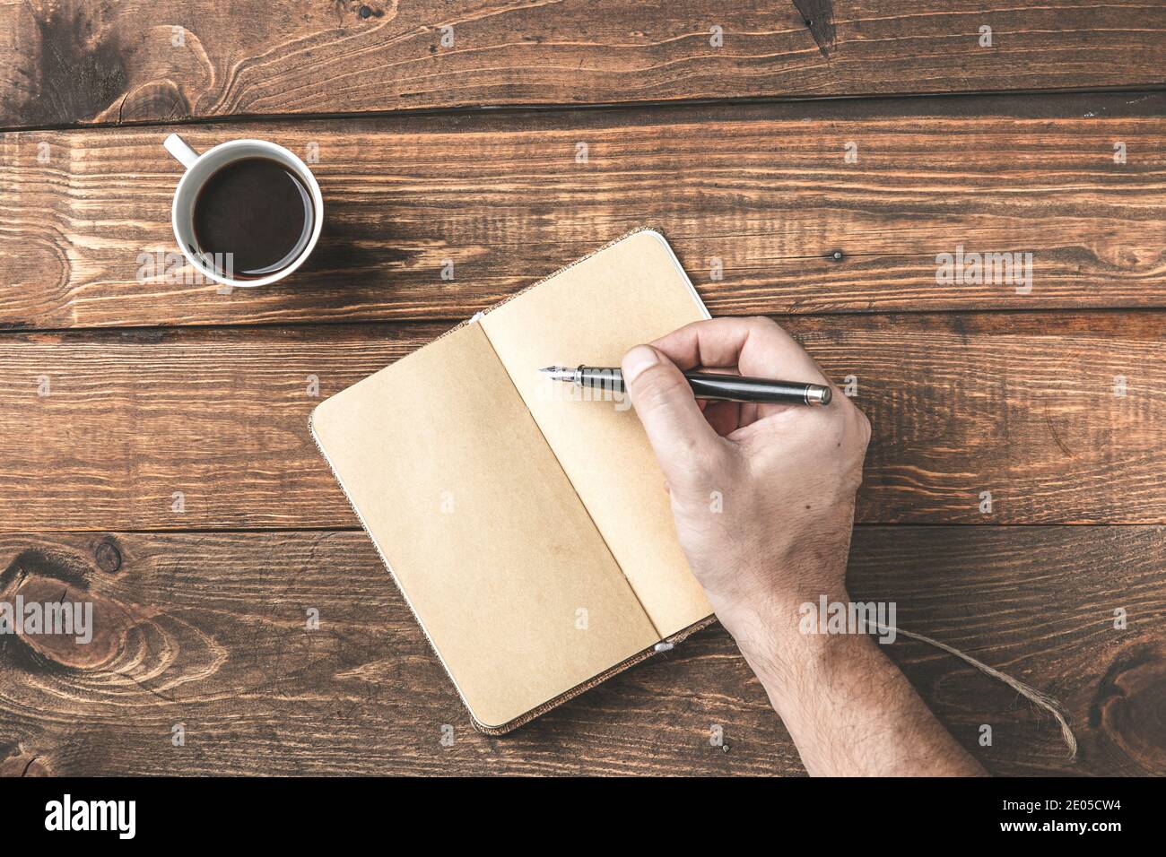 Simple work place. Wooden office desk table, with hand writing on an ...