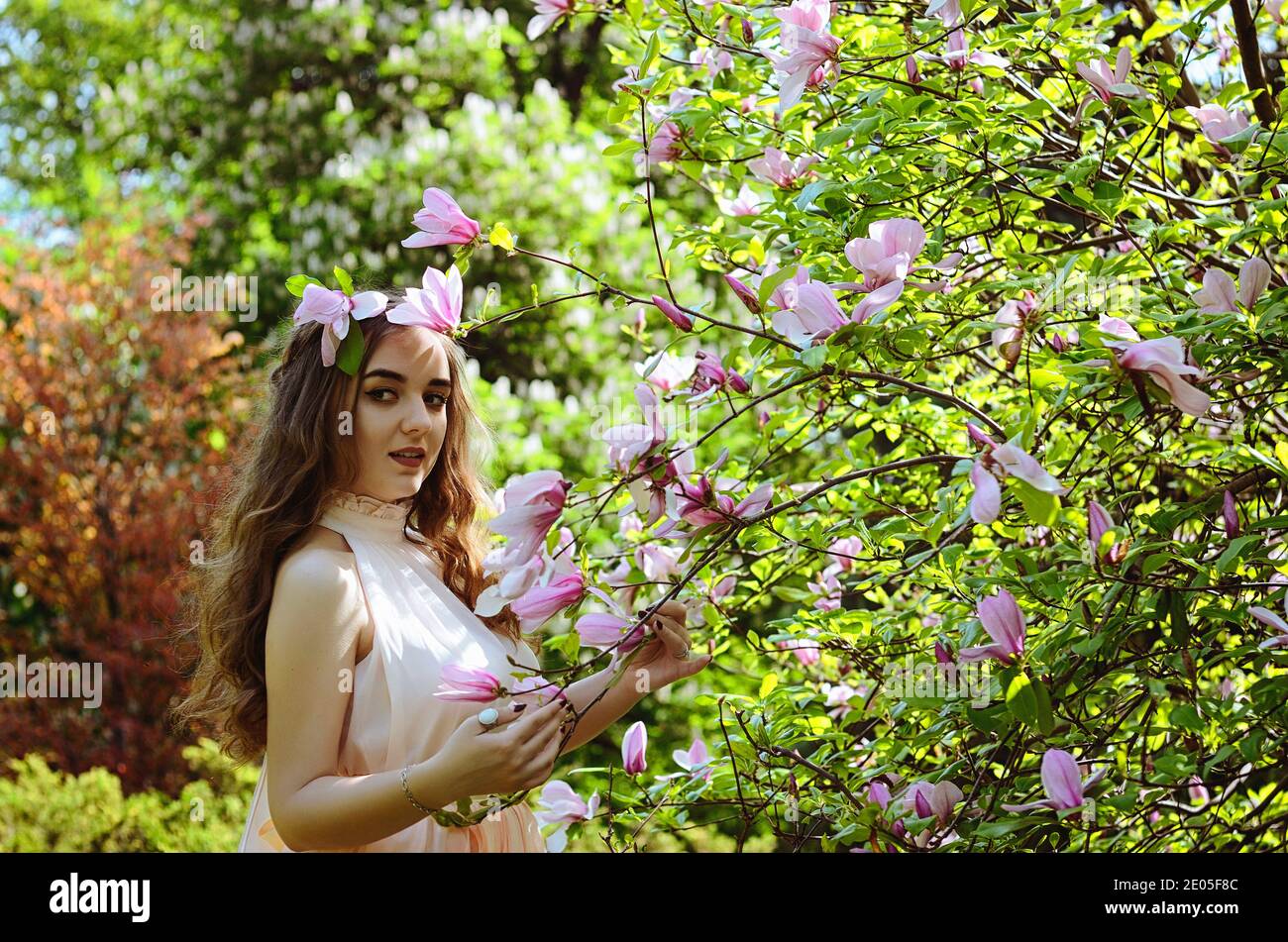 Portrait of young attractive woman in spring garden with blooming ...
