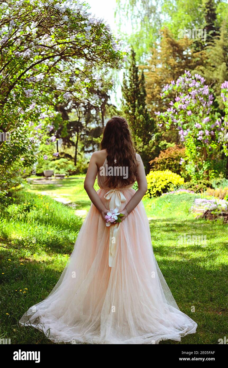 Portrait of young attractive woman in spring garden with blooming ...