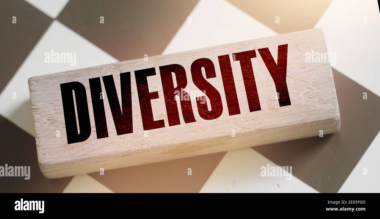 Diversity word written on wooden block on chess board. Selective focus ...