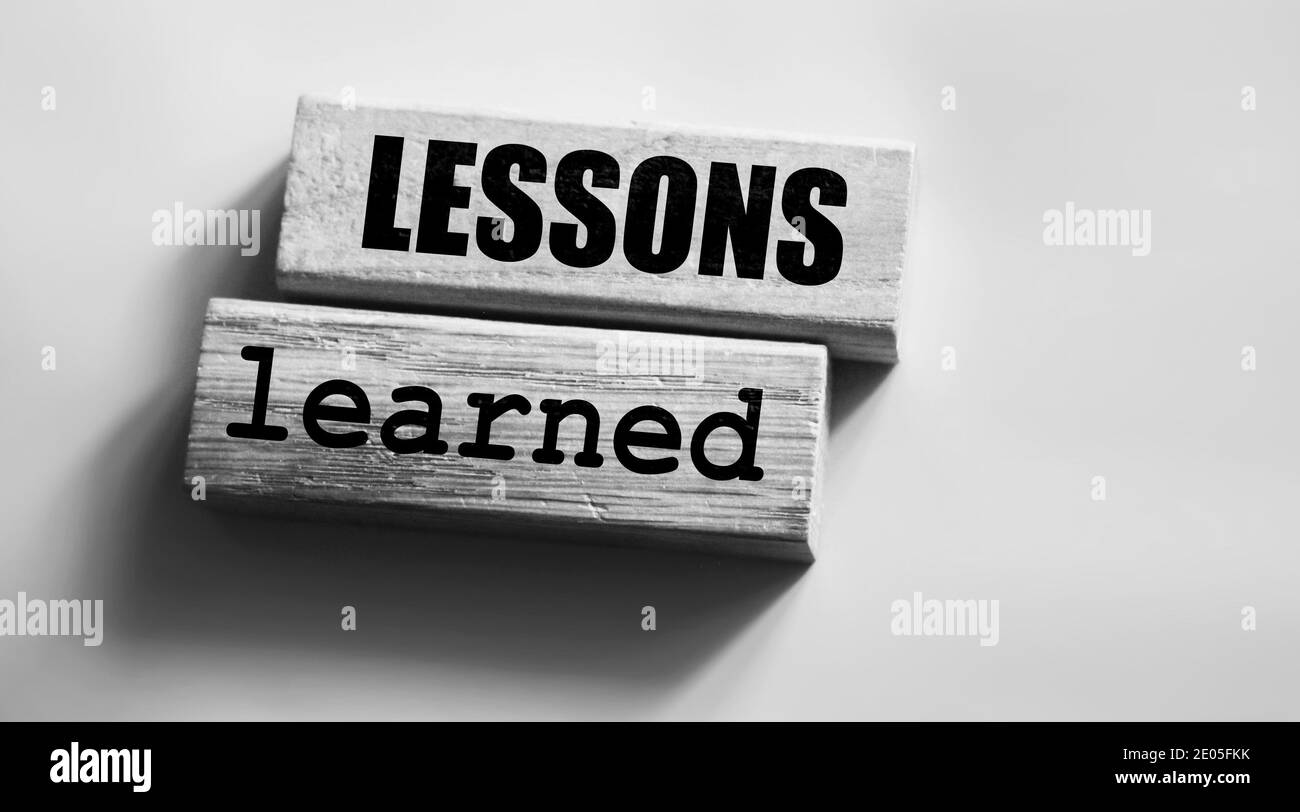 Lessons learned text on Wood blocks on pink. Business education concept ...