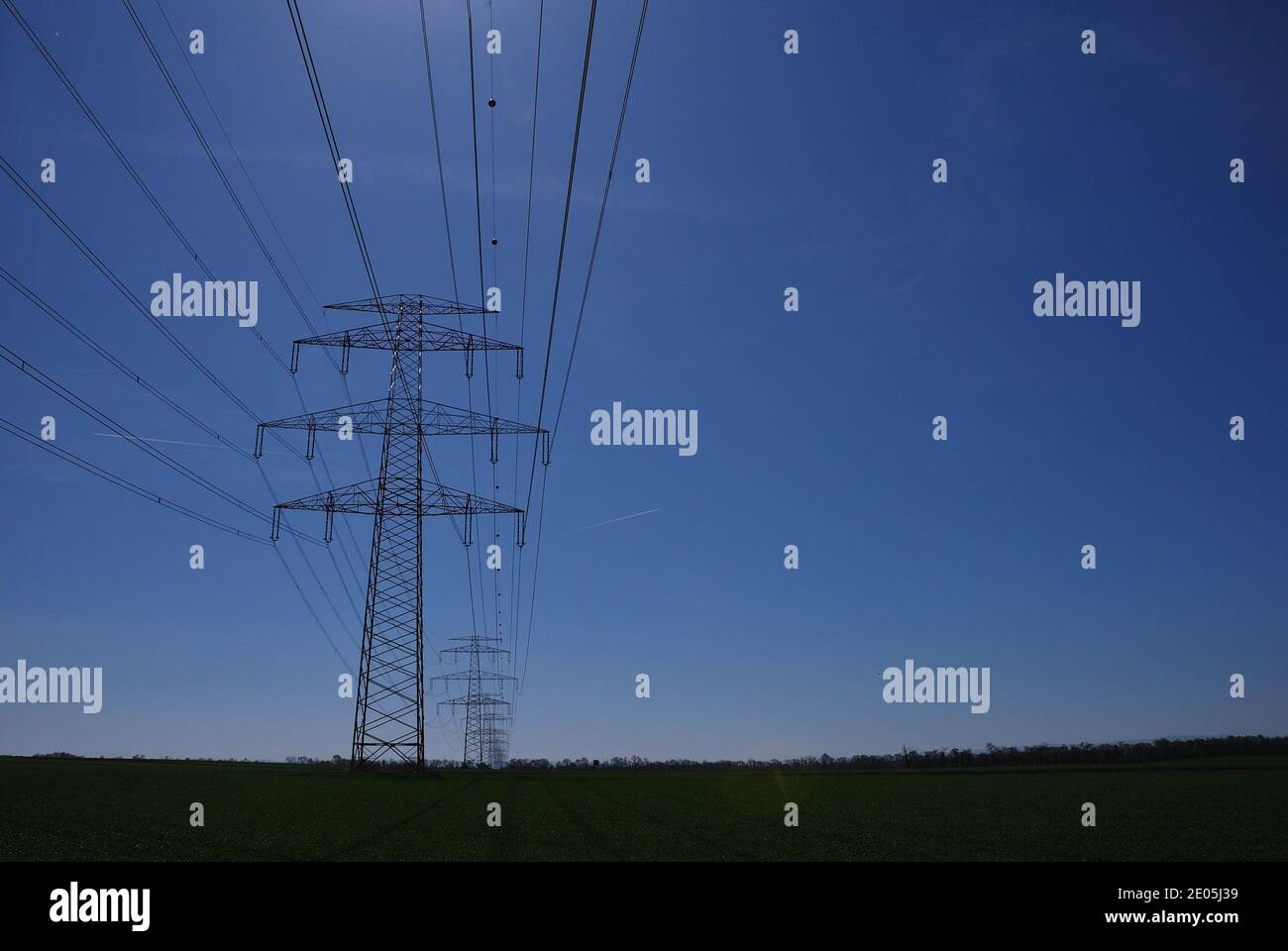 many power poles in a row to the natural horizon Stock Photo - Alamy