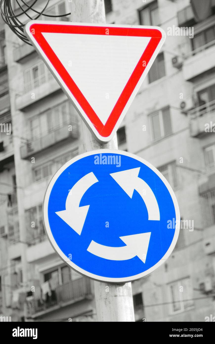 Traffic sign against the black and white building background. Road sign ...