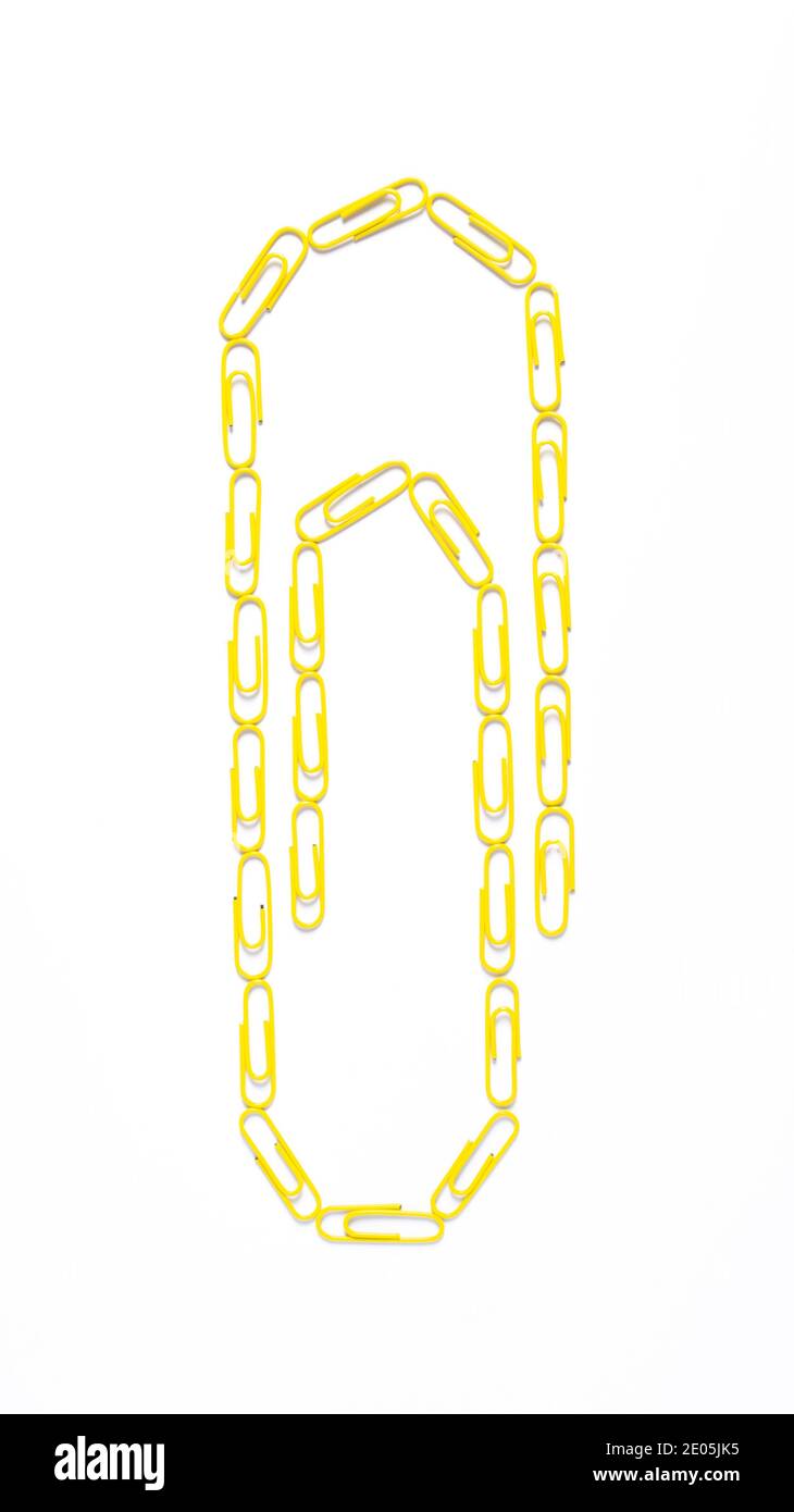 Paper clip form made from yellow paper clips on white background.Top ...