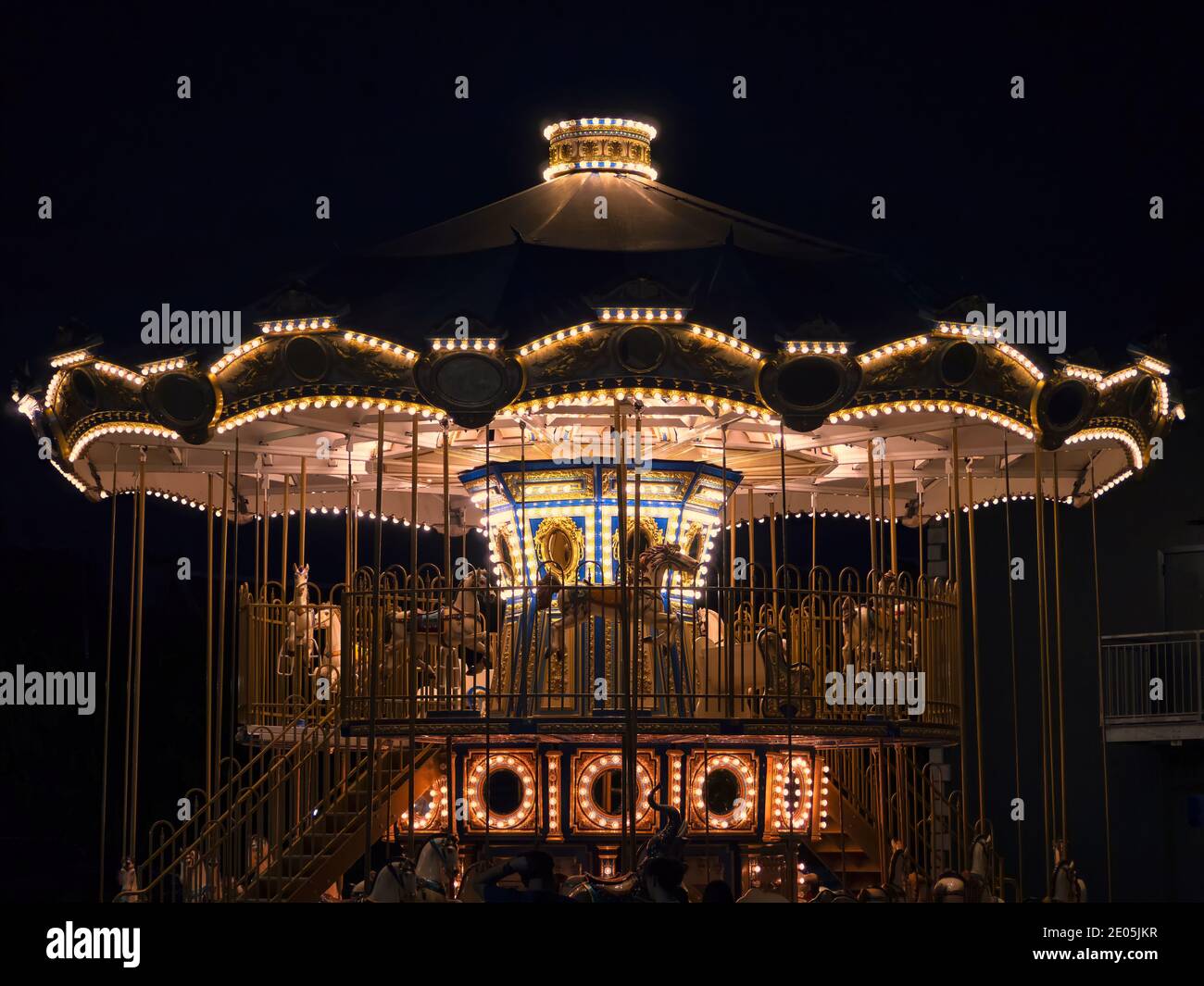 The carousel in the amusement park in the lights at night Stock Photo ...