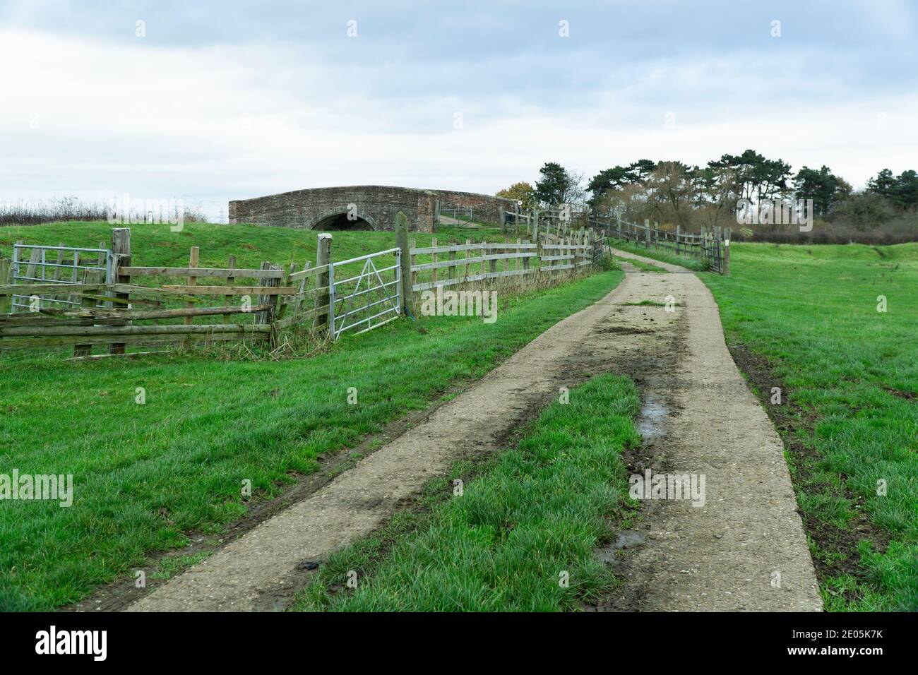 Farm dirt track leading to a bridge Stock Photo - Alamy