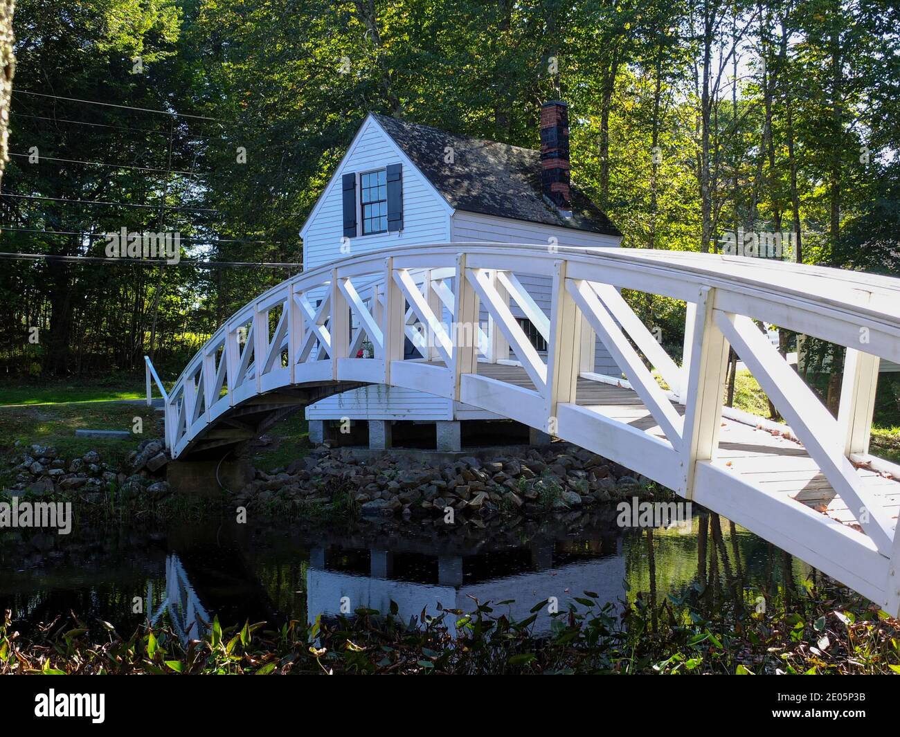 Arch shaped bridge by cottage Stock Photo - Alamy