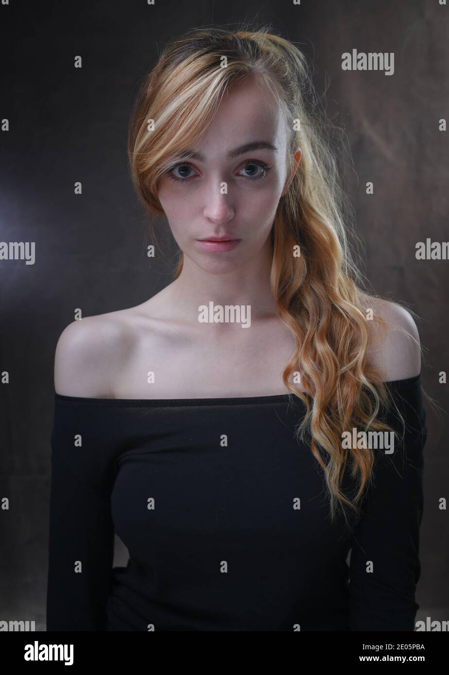 Strong portrait of a young beautiful woman ( 20 ) looking straight to ...