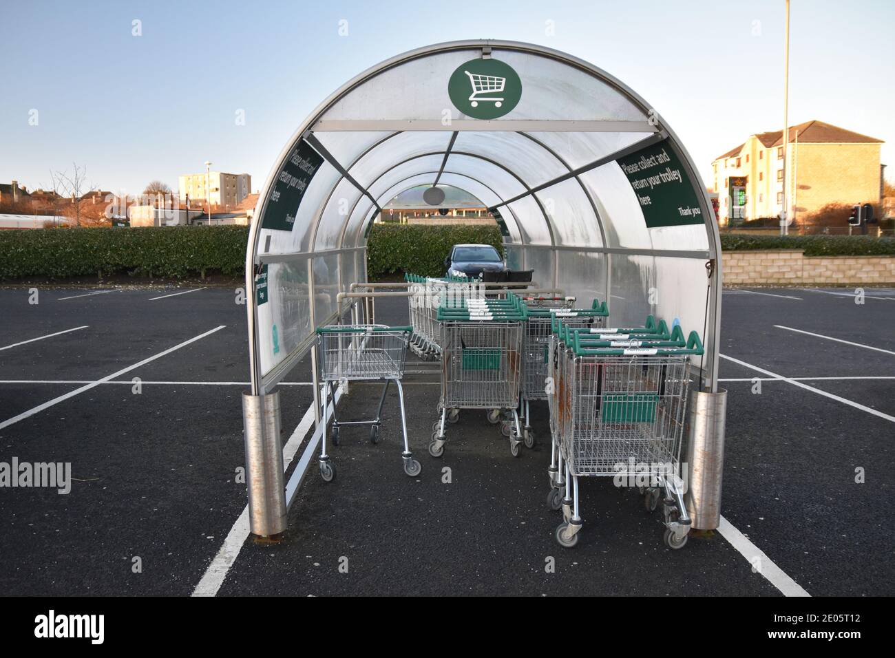 Lines of shopping trolleys in trolley park in car park of Morrisons ...