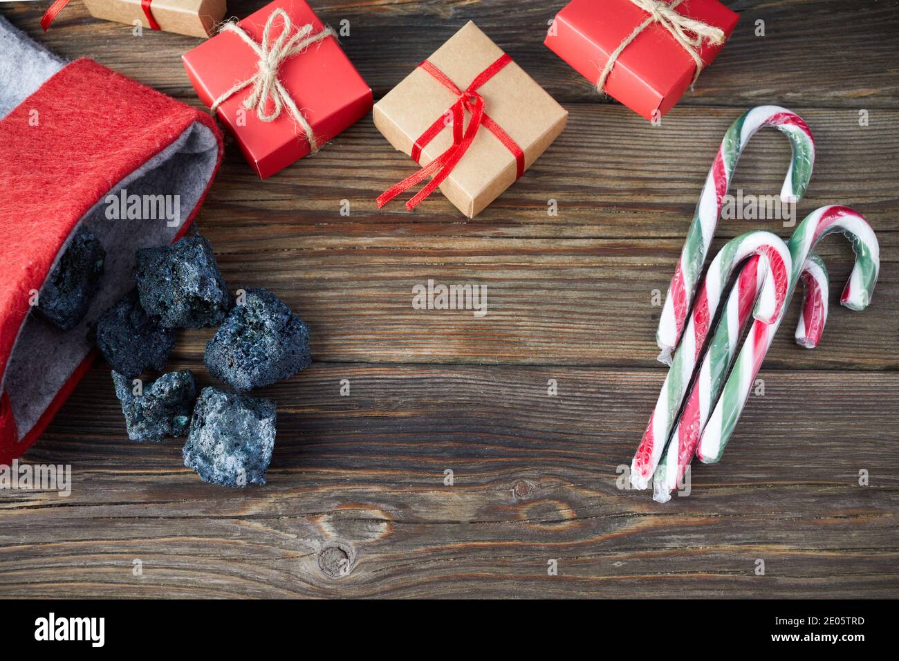 The Befana sock with sweet coal and candy on wooden background. Italian ...