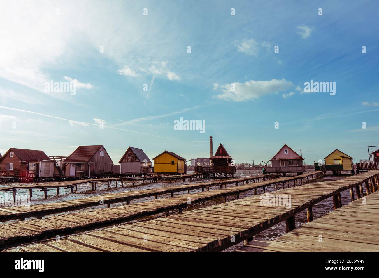 Hungarian village built over the lake Bokod. Wooden walkways leading to ...