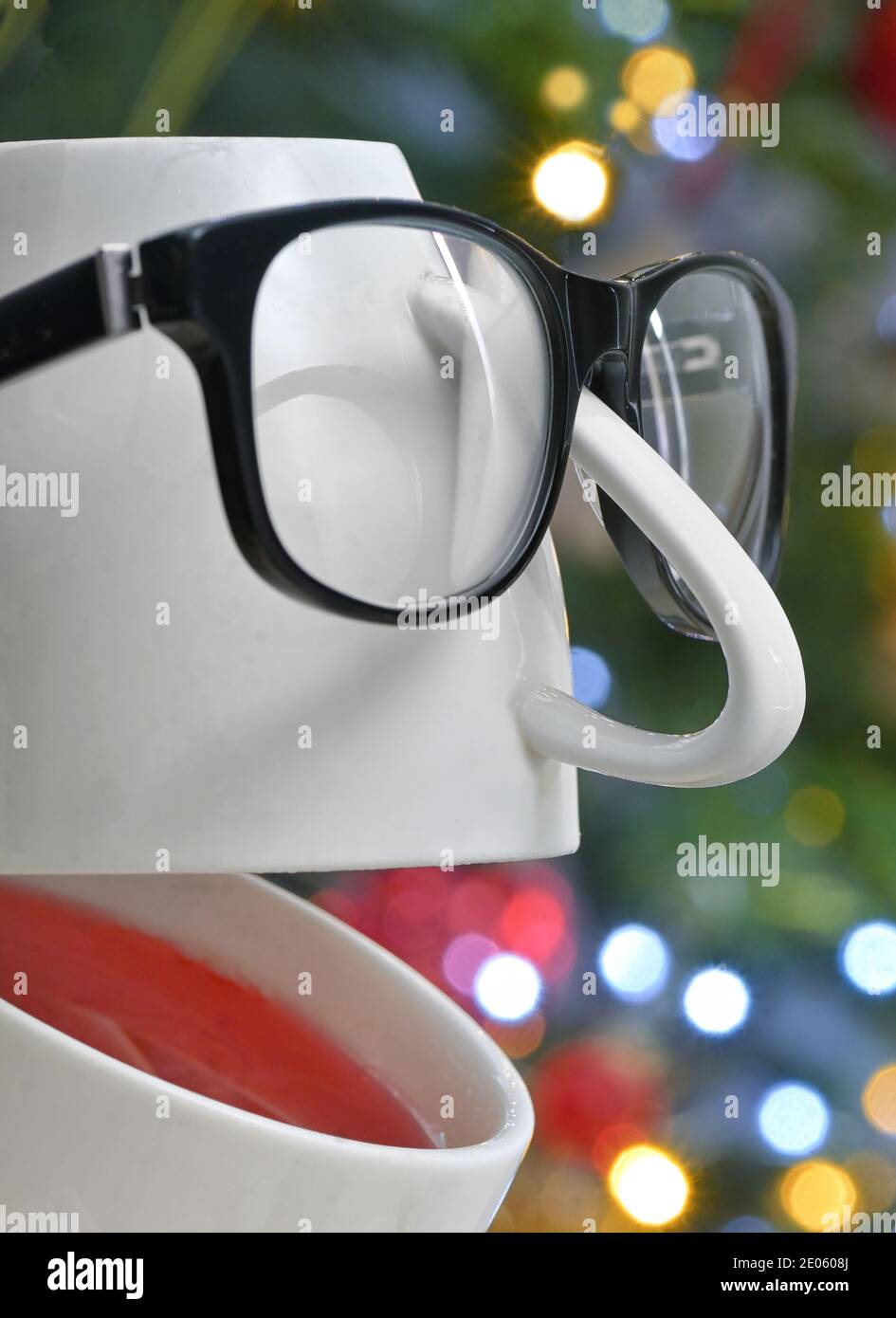 Conceptual Teacup with Eyeglasses Laughing with holidays background ...