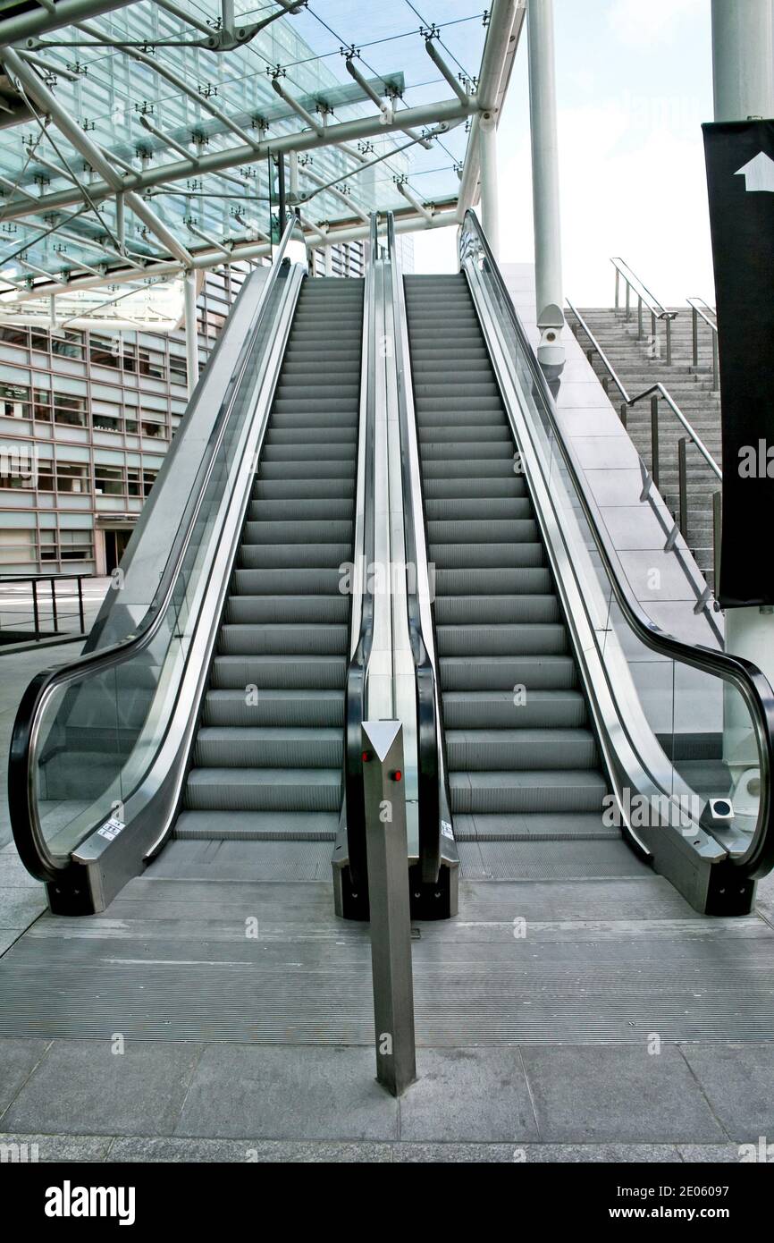 Two parallel automatic escalators in business building Stock Photo - Alamy