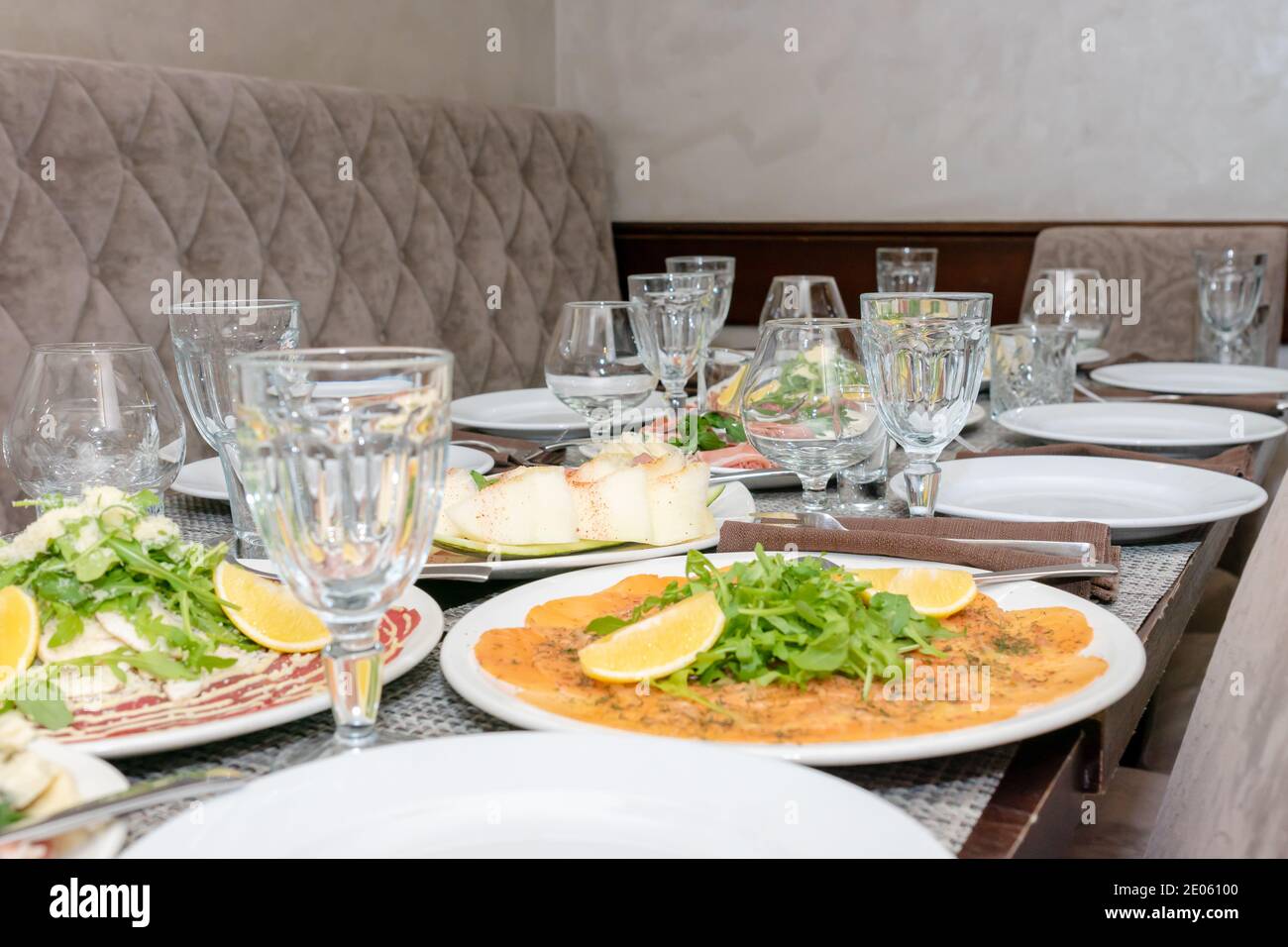 Festive table setting, family dinner with served italian antipasti ...