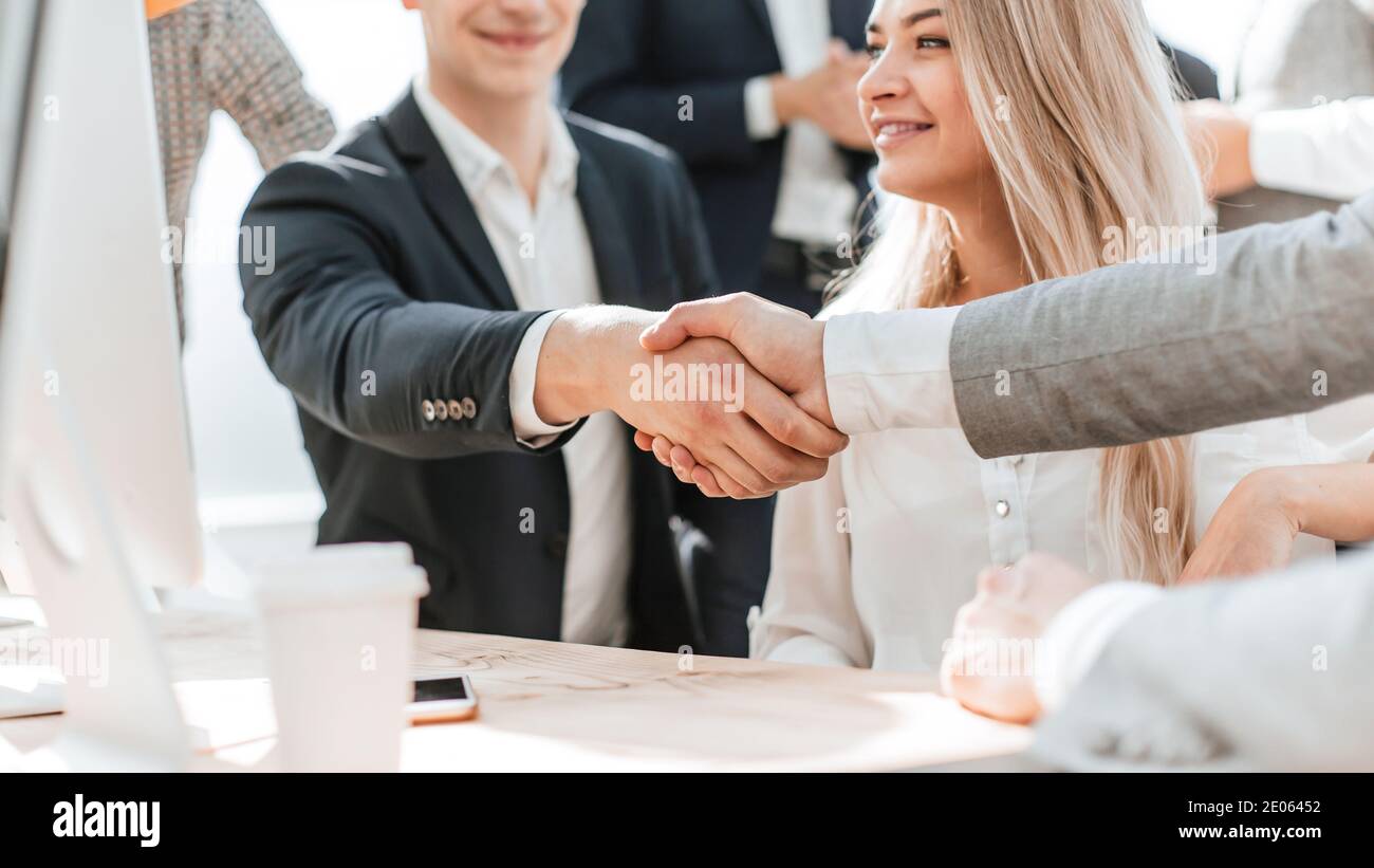 close up. Manager shaking the hand of the Bank customer Stock Photo - Alamy