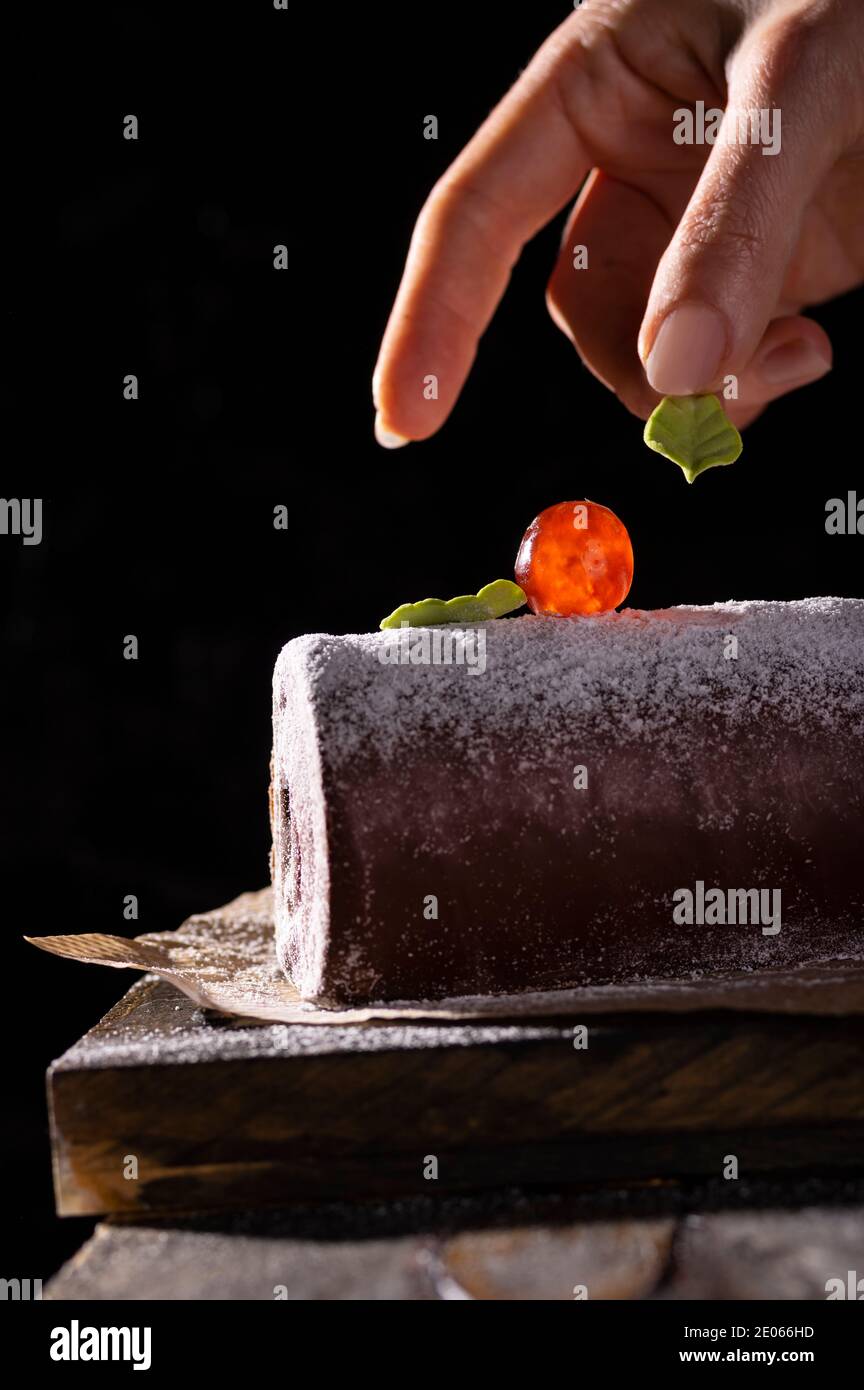 Chocolate swiss roll cake roulade decorated with sugar cherry and icing ...