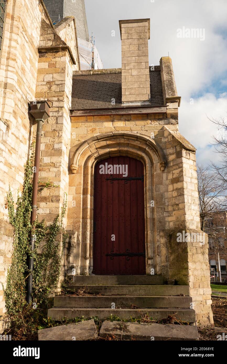 the back door with old broken stairs and wall of a church building ...