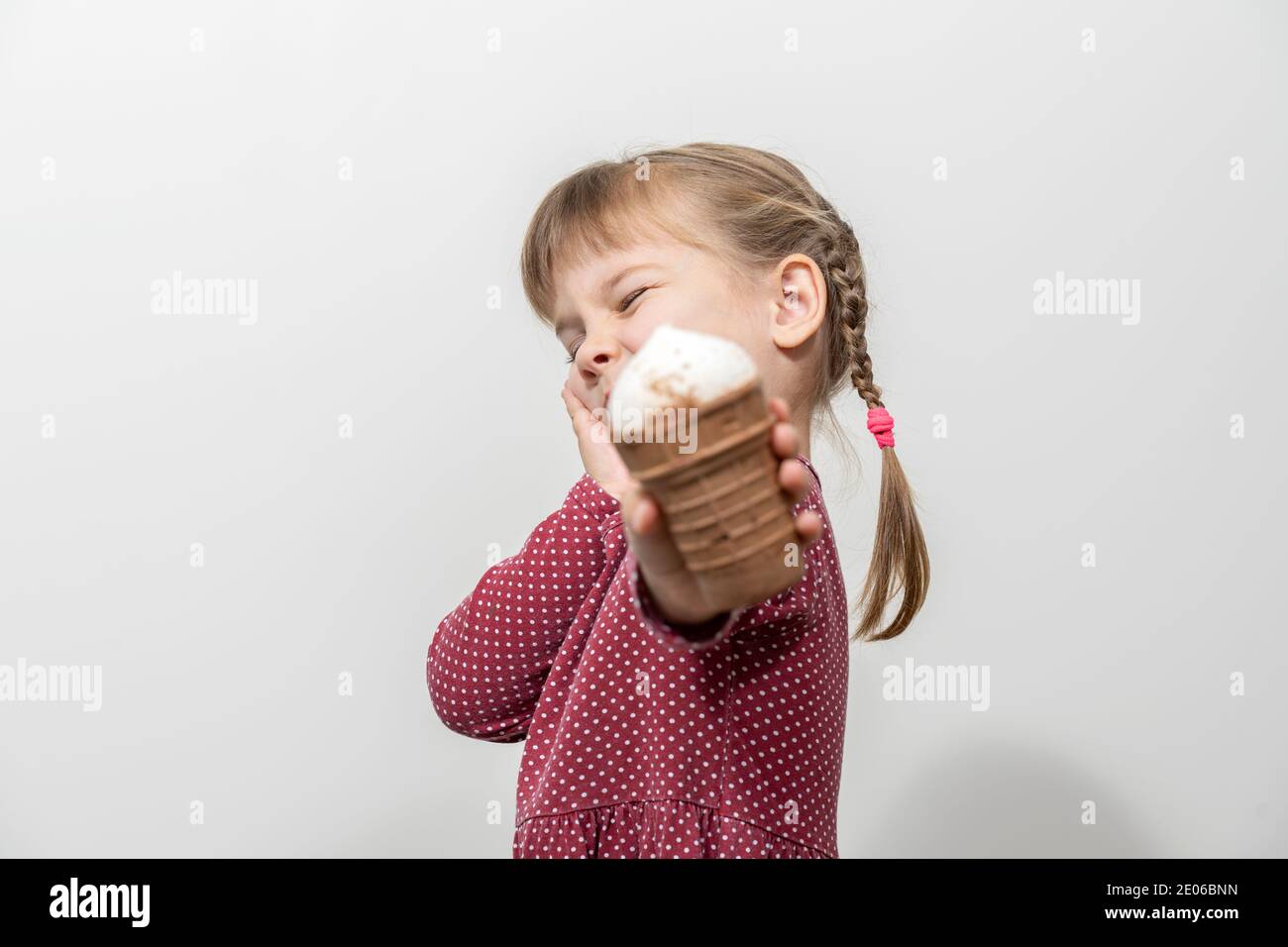 Girl has a toothache from cold ice cream. the child refuses dessert ...