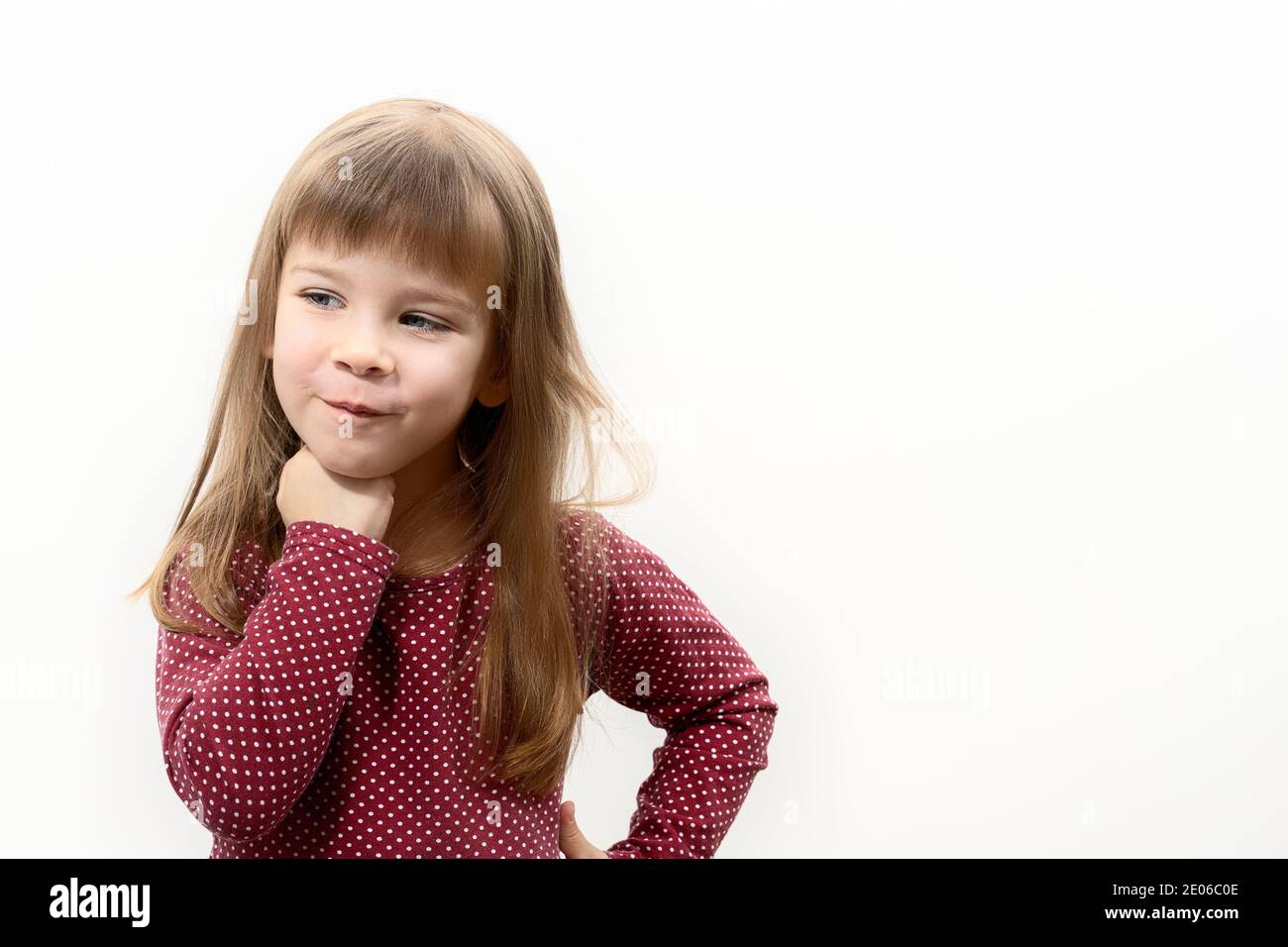 beautiful caucasian kid girl is planning something. sly look. layout ...